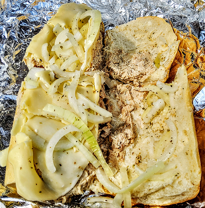 A sandwich so generous it requires structural engineering&mdash;layers of chicken, cheese, and onions spilling out like a delicious architectural marvel.
