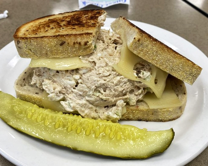 A tuna melt that respects tradition while delivering comfort. The pickle isn't just garnish&mdash;it's the acidic counterpoint this sandwich masterpiece demands. 