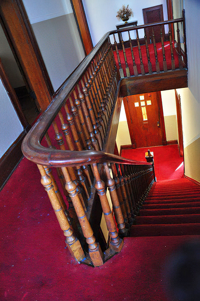 The craftsmanship of this banister would be impressive if it weren't for the nagging feeling that someone's watching you from the landing above.