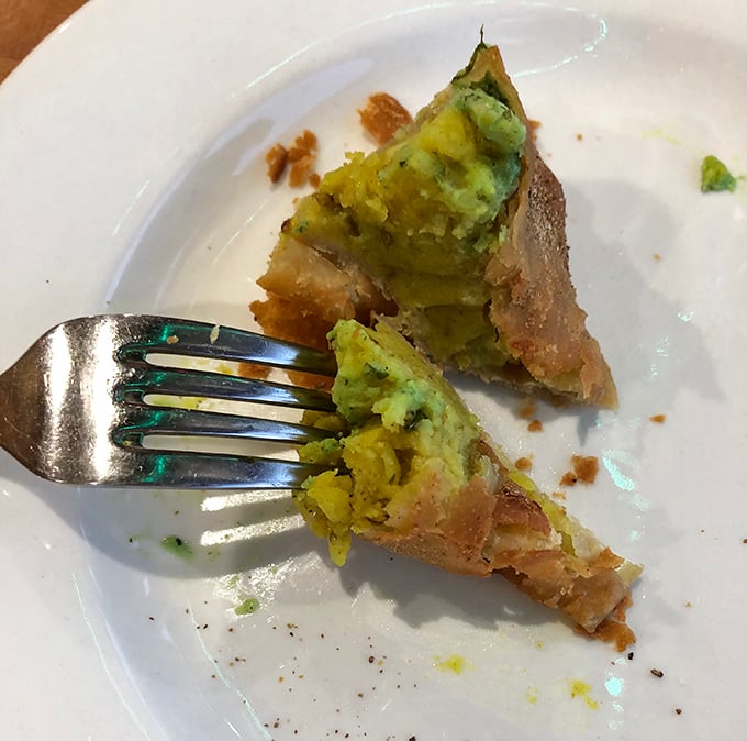 Cut into this golden-fried samosa and watch the steam escape, revealing a perfectly spiced potato filling that's worth every delicious calorie.