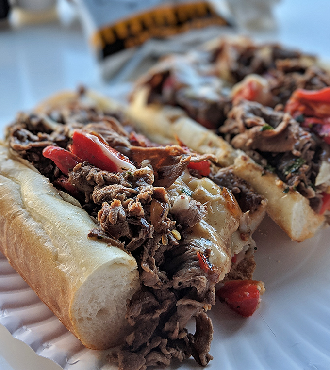 This loaded cheesesteak, packed with tender beef, melty cheese, and peppers, is a flavor explosion in every bite.