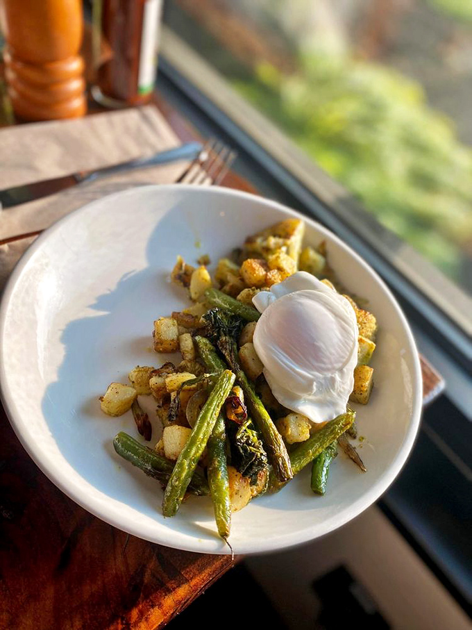 Roasted green beans and potatoes playing supporting roles to a perfectly poached egg. Proof that vegetables can be the life of the breakfast party.