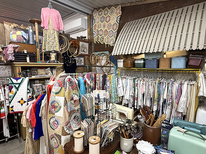 A seamstress's dream corner filled with vintage fabrics, handcrafted quilts, and sewing notions. Each stitch represents hours of patient artistry.