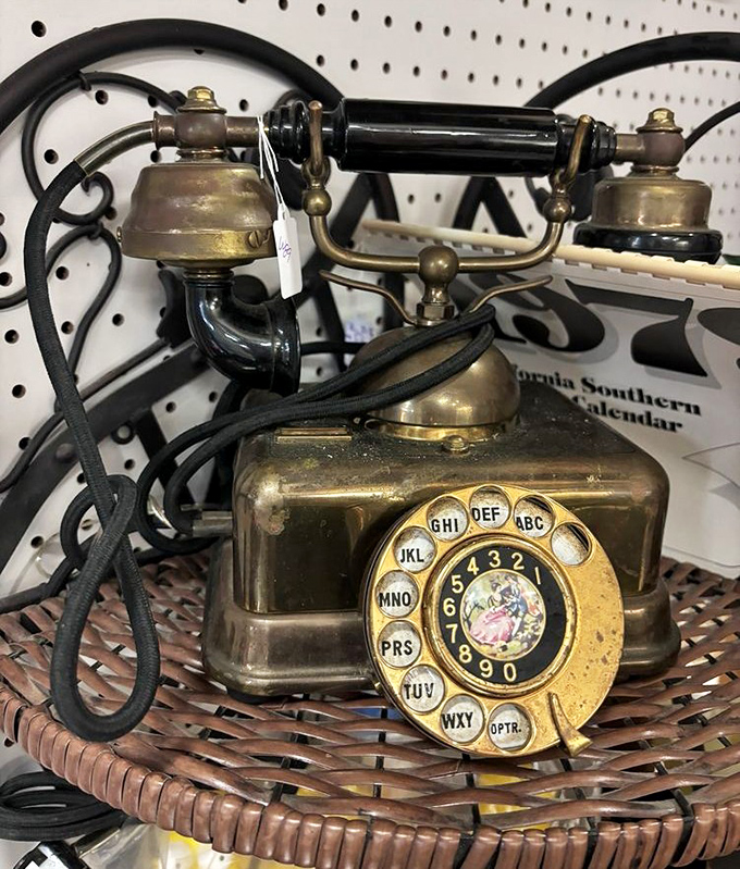 This brass beauty isn't just a telephone—it's a portal to an era when "hanging up" required actual physical effort.