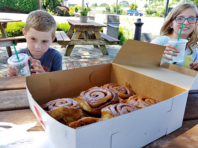 The universal language of anticipation: people patiently waiting for their turn at sticky bun nirvana, calculating how many they can reasonably order.