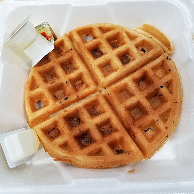 A proper waffle with those perfect square divots&mdash;nature's ingenious syrup-catching technology at its finest.