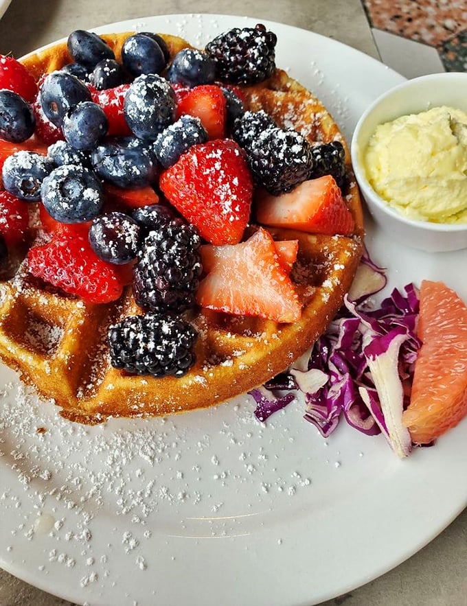 A waffle that's basically a fruit delivery system – blueberries, strawberries, and blackberries playing their delicious roles in this breakfast theater production.