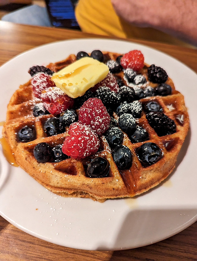 This isn't just a waffle&mdash;it's architecture with berries. The butter melting into those perfect squares is nature's most beautiful geometry.