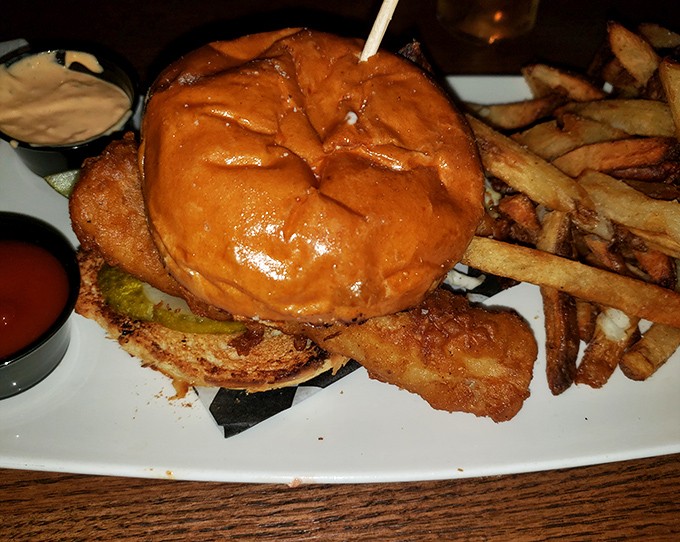 This isn't just a burger &ndash; it's architecture, engineering, and art stacked between buns with fries standing at attention alongside.