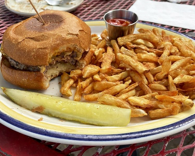The classic American burger gets elevated with golden fries and a pickle spear&mdash;a trio that's been making bad days better since time immemorial.