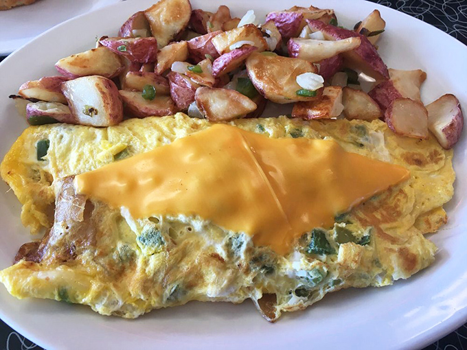 This Western omelet doesn't just contain peppers and cheese—it showcases them like headliners at a culinary concert.