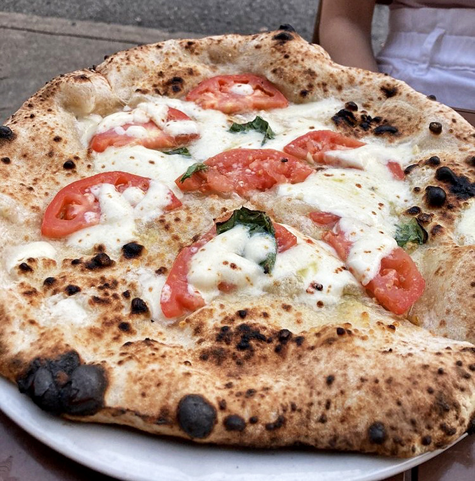 Fresh tomatoes and milky mozzarella on that blistered crust&mdash;the Bianca pizza is minimalism that maximizes flavor. Less is more, unless it's cheese.