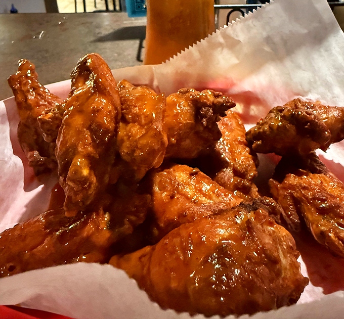 Wings so perfectly sauced they should come with a warning label: "May cause spontaneous happiness and temporary inability to maintain table manners."