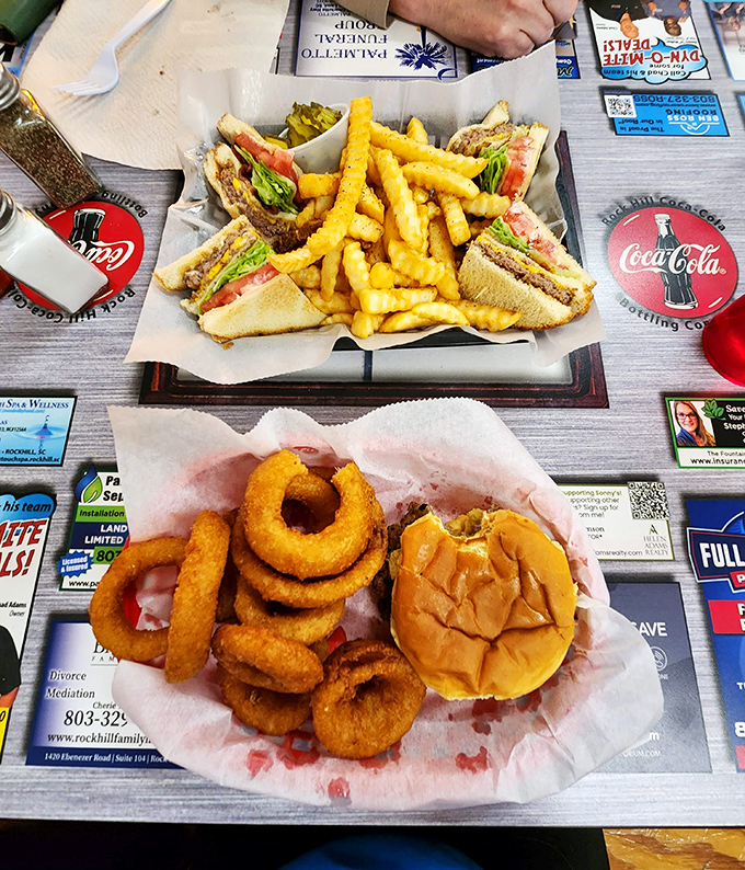 A feast fit for royalty served on humble paper. Those golden onion rings and perfectly toasted bun are the crowning jewels of diner cuisine.