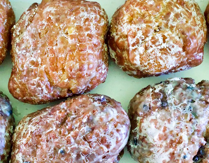 Apple fritters the size of small dinner plates&mdash;where chunks of real fruit meet a crackling exterior that shatters like delicious stained glass.