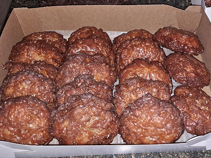 Apple fritters that could start a family feud. The powdered sugar isn't decoration&mdash;it's the final blessing in this crispy-sweet sermon.