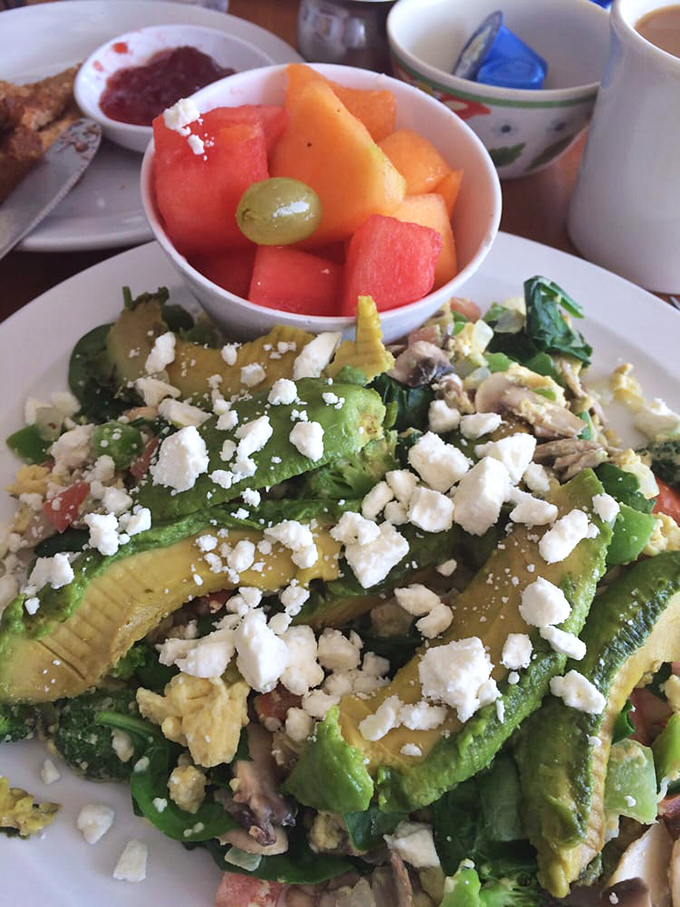 Scrambled eggs get the VIP treatment with fresh avocado slices that make every bite feel like a celebration.