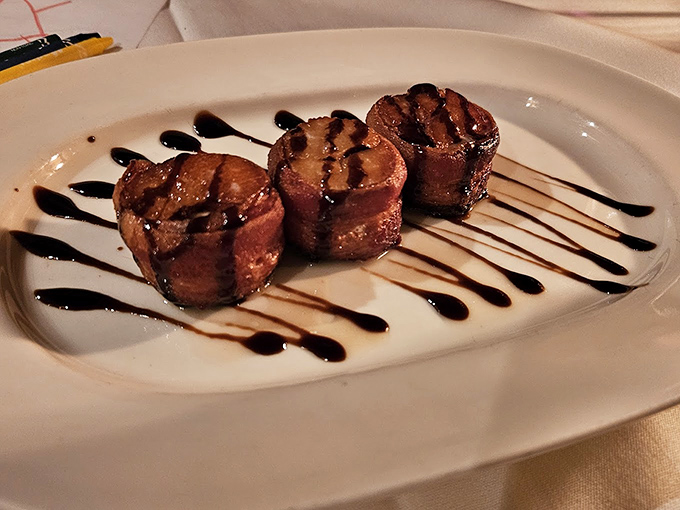 Bacon-wrapped scallops drizzled with balsamic reduction&mdash;proof that sometimes the simplest combinations are culinary magic in disguise.