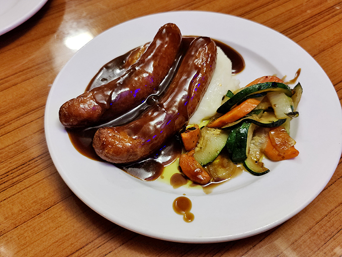Bangers and mash with proper onion gravy&mdash;the kind of honest plate that makes you wonder why anyone bothers with foam and microgreens.