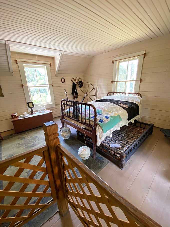 Bedroom goals from another century: iron bed frame, handmade quilt, and not a charging cable in sight. Sleep quality: pioneer-approved.