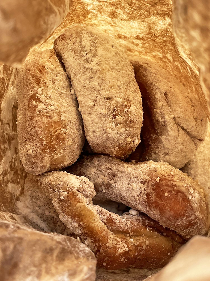 These sugar-dusted beignets aren't just pastries&mdash;they're little pouches of joy that crackle with each bite, releasing their cinnamon secrets.