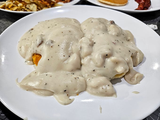 Biscuits swimming in creamy, peppery gravy &ndash; the kind of Southern comfort that makes you want to hug the chef afterward.