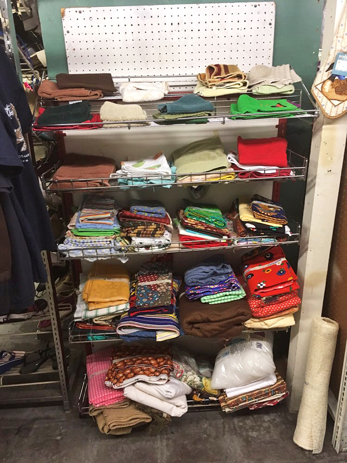 Linens and textiles stacked with surprising precision &ndash; each folded blanket holding stories of past comfort, ready for new chapters in different homes.