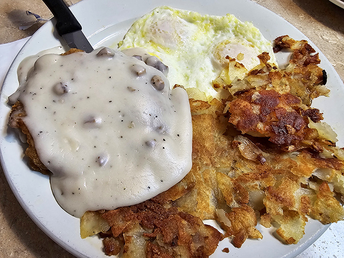 Gravity-defying hash browns topped with sausage gravy &ndash; proof that sometimes the best architecture in town isn't in buildings but on breakfast plates.