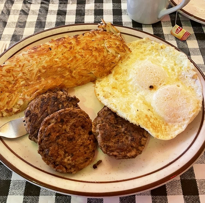 The breakfast combo that launched a thousand road trips &ndash; eggs, meat, and sides in perfect diner harmony.