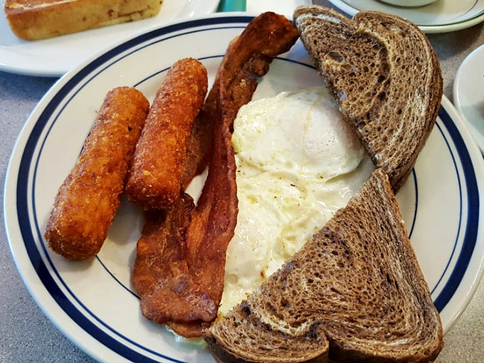 The breakfast trinity: perfectly cooked eggs, crispy bacon, and toast ready for whatever jam adventure you choose to embark upon.