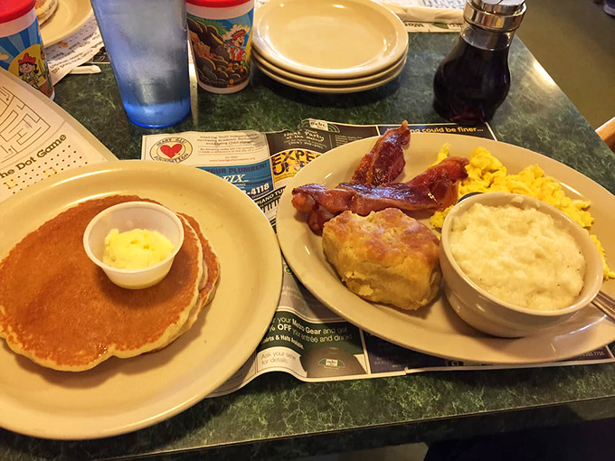 Pancakes and breakfast classics sharing a plate like old friends at a reunion. The butter melting on those pancakes is performing a slow dance.