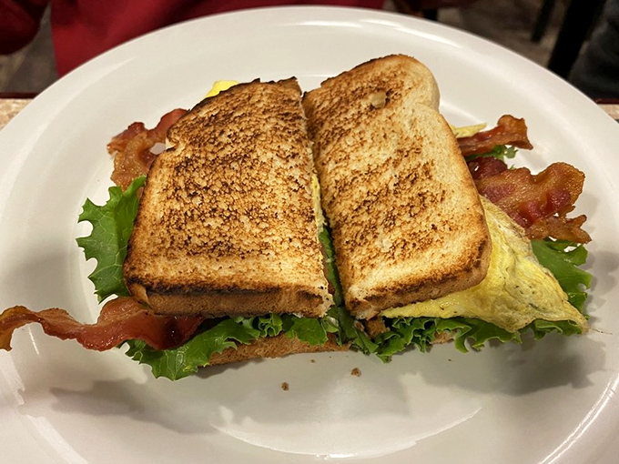 A breakfast sandwich that means business, where bacon and eggs meet their destiny between perfectly toasted bread.