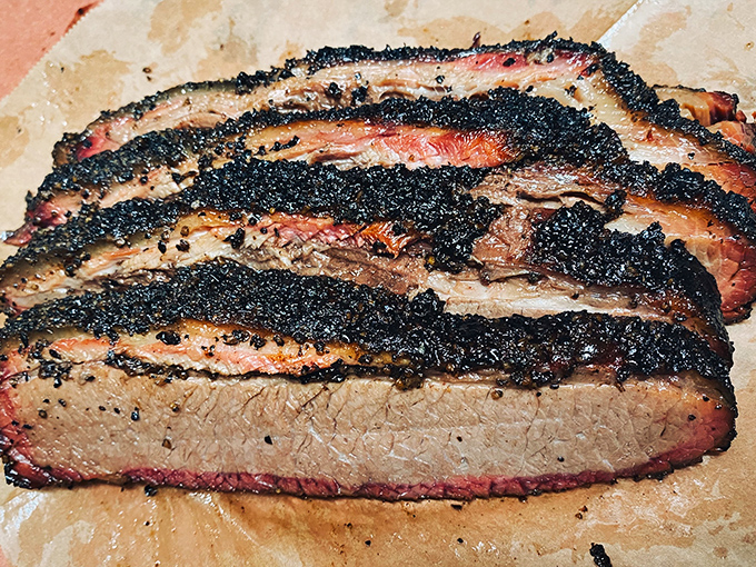 This brisket showcases the perfect smoke ring that barbecue dreams are made of, slice by slice.