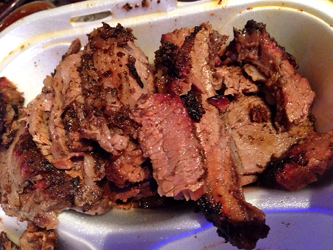 Brisket with that telltale pink smoke ring&mdash;visual evidence of the low-and-slow philosophy that separates the great from the good.