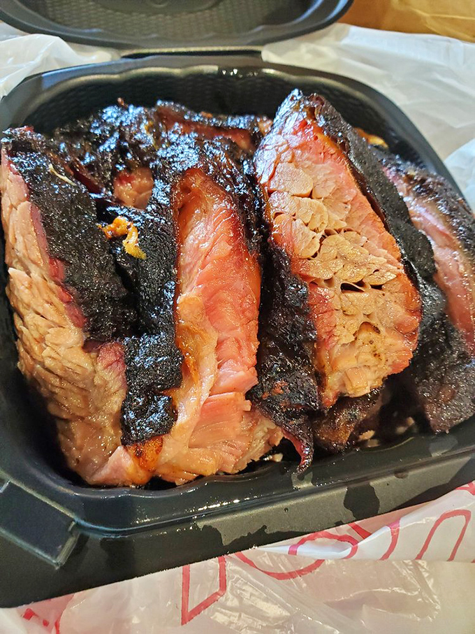 Brisket with a smoke ring so perfect it could be framed, sliced thick enough to showcase its juicy tenderness yet thin enough for maximum flavor impact.