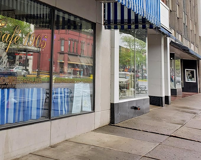 Caf&eacute; 1905 reflects in its own windows, promising homestyle comfort in a setting that hasn't surrendered to chain-store uniformity.