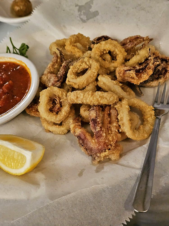 Crispy calamari that shatters with each bite, served with marinara that's clearly never seen the inside of a jar. The lemon wedge isn't just garnish—it's essential.