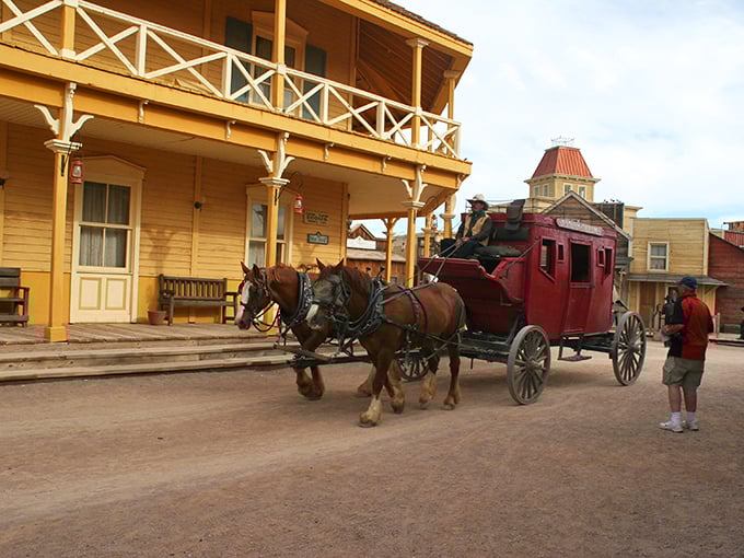 Nothing says "authentic Western experience" like clip-clopping down Main Street in a stagecoach that's survived more fictional robberies than actual miles.
