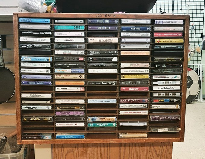 A wooden cassette display that's practically a museum exhibit. Gen Z calls this "vintage media" &ndash; the rest of us call it "Tuesday afternoons in 1988."