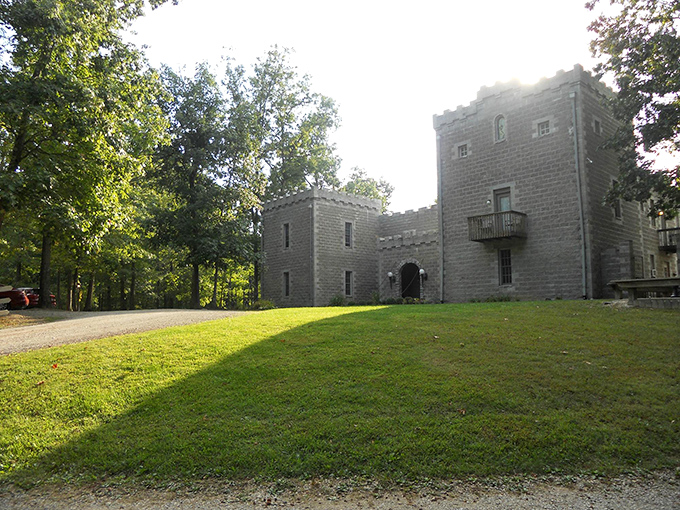 Sunlight bathes the castle grounds, highlighting the impressive stonework and creating a picturesque scene worthy of any fairy tale setting.