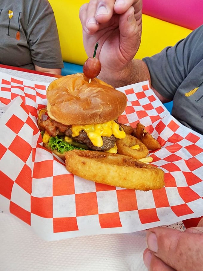 The burger arrives like a savory exclamation point&mdash;complete with melty cheese, crispy onion rings, and a cherry on top that says, "Yes, we're having fun here!" 