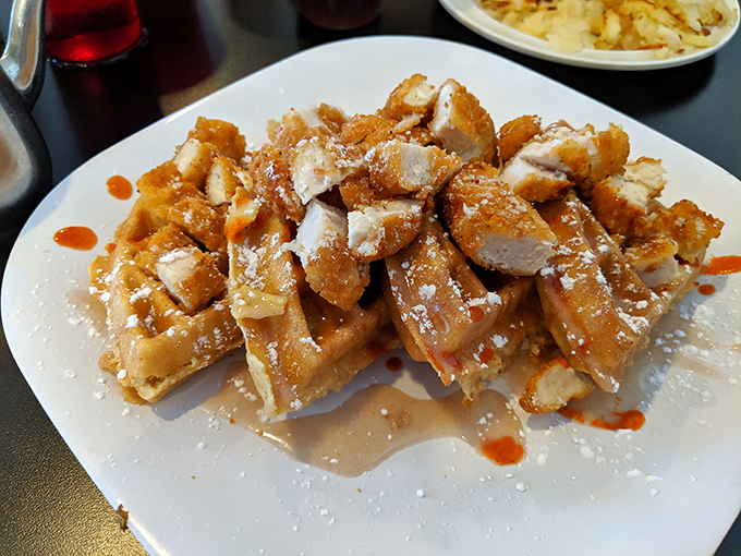 Chicken and waffles with a drizzle of syrup – the dish that settles the sweet-versus-savory breakfast debate with a definitive "why not both?"
