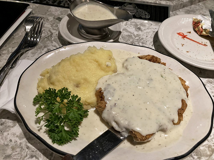 Country-fried steak smothered in peppery gravy alongside cloud-like mashed potatoes&mdash;comfort food elevated to an art form.