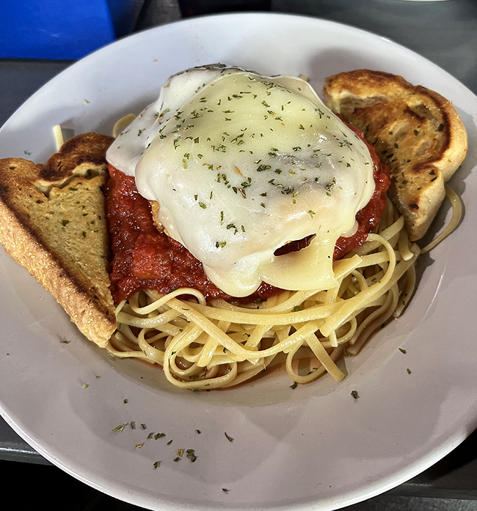 Chicken parmesan that's having an identity crisis &ndash; is it Italian? American? No, it's just delicious, especially with that garlic bread sidekick.