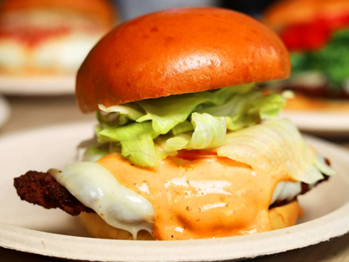That burger looks like it means business, with cheese melting like a delicious avalanche of flavor.