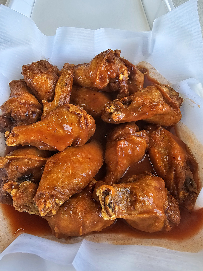 Wings that don't need a sports bar to shine. Glistening with sauce and promising the perfect balance of heat and sweet.