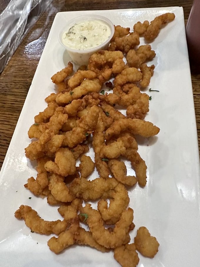 Clam strips piled high like edible gold nuggets, just waiting to disappear one crispy bite at a time.