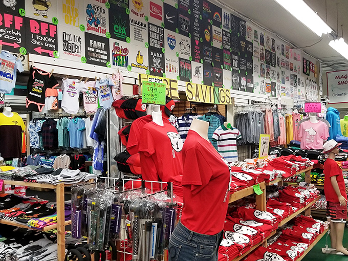 T-shirt heaven with enough options to clothe a small nation. The wall of designs behind could be its own art installation.