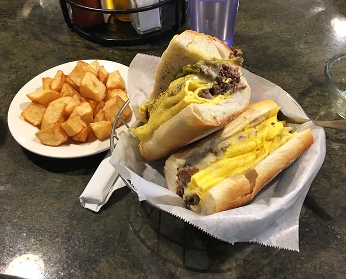 A cheesesteak with a side of perfectly golden home fries &ndash; proof that sometimes the best things in life come in paper baskets.