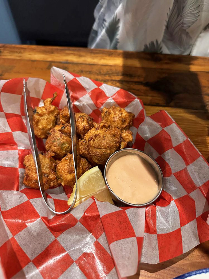 Golden-fried conch fritters with dipping sauce&mdash;little spheres of happiness that transport you straight to a Key West sunset without the sunburn.